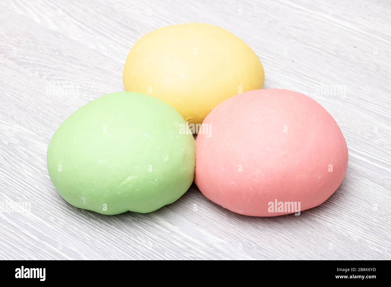 Pink, yellow and green dough for pasta, colored with natural dyes Stock ...