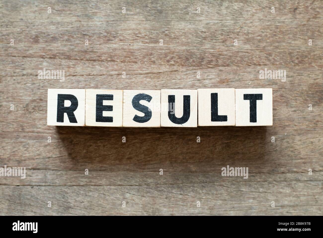 Letter block in word result on wood background Stock Photo - Alamy