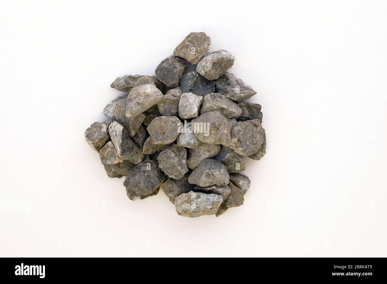 Gray silicon stones on a white background top view. Flint natural stone ...