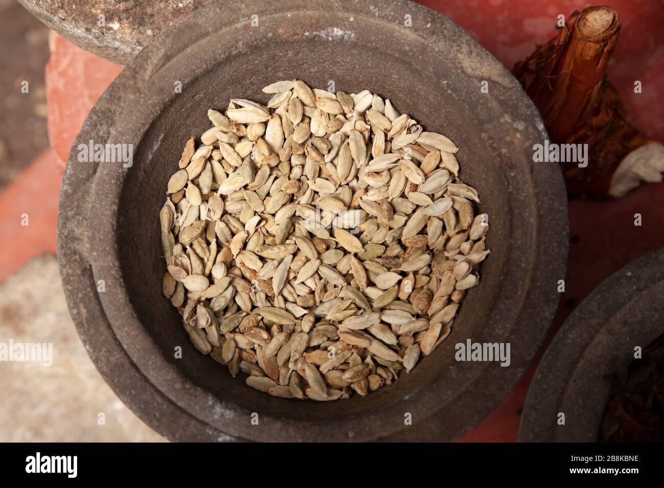 Display of cardamon pods or seeds, in grey stone pot in Penang ...