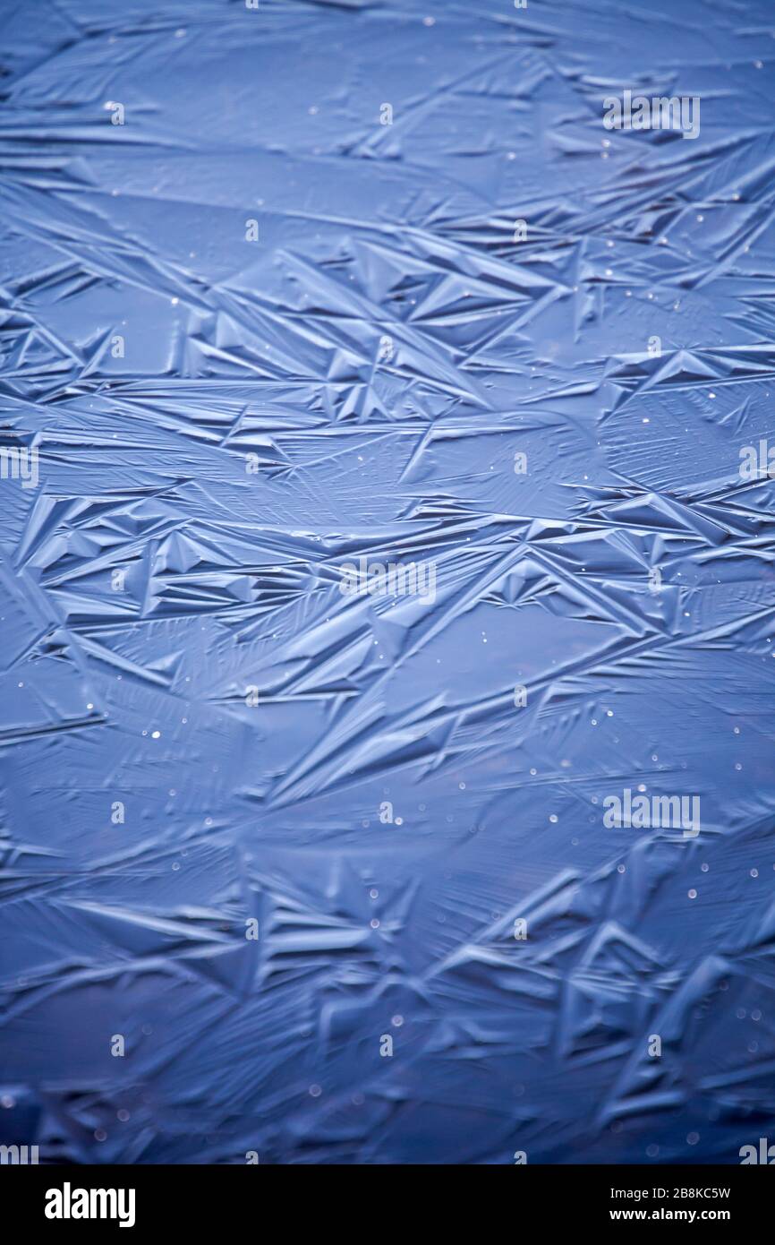 Frozen water with interesting patterns in blue Stock Photo - Alamy