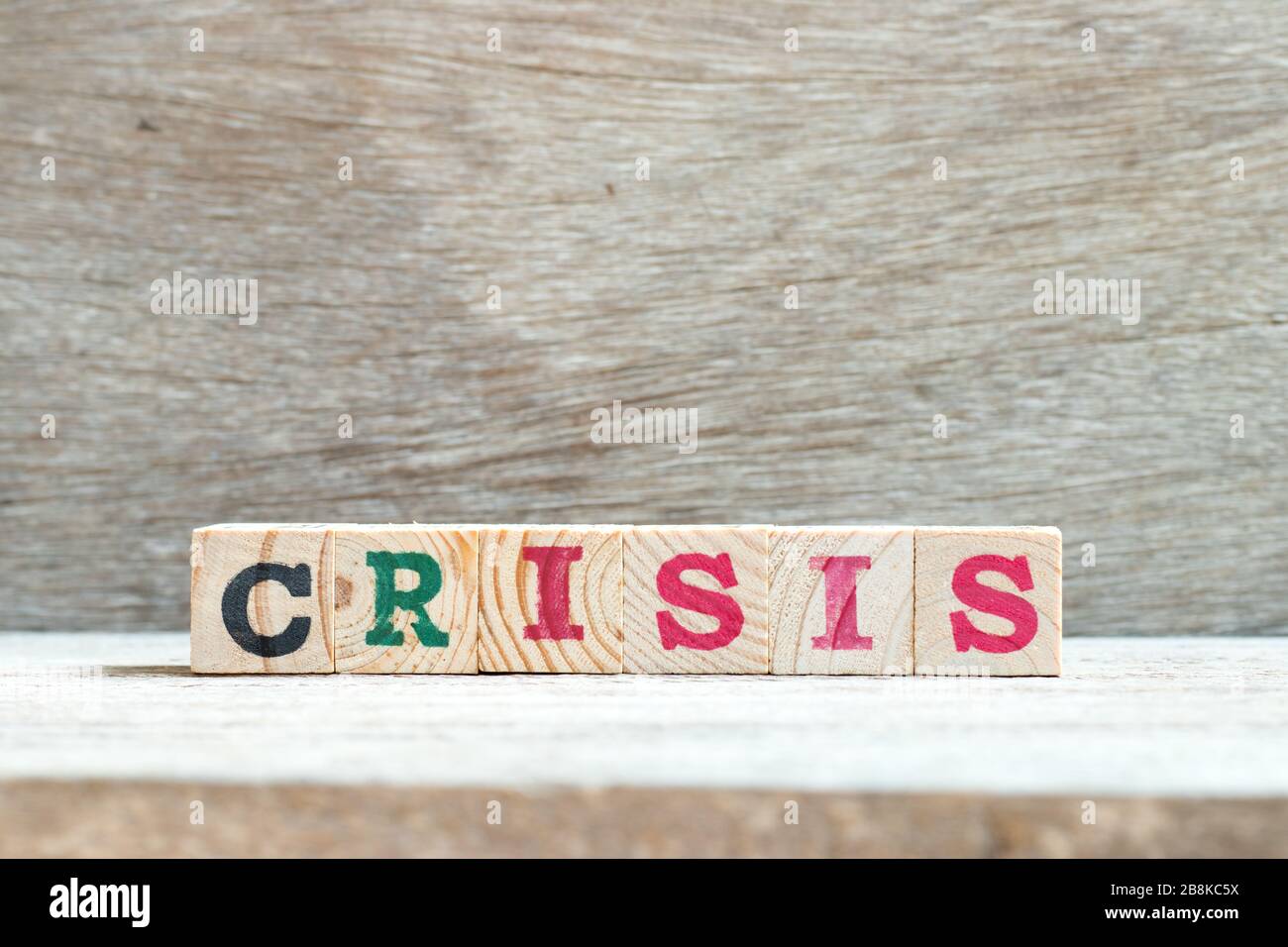 Alphabet letter in word crisis on wood background Stock Photo - Alamy