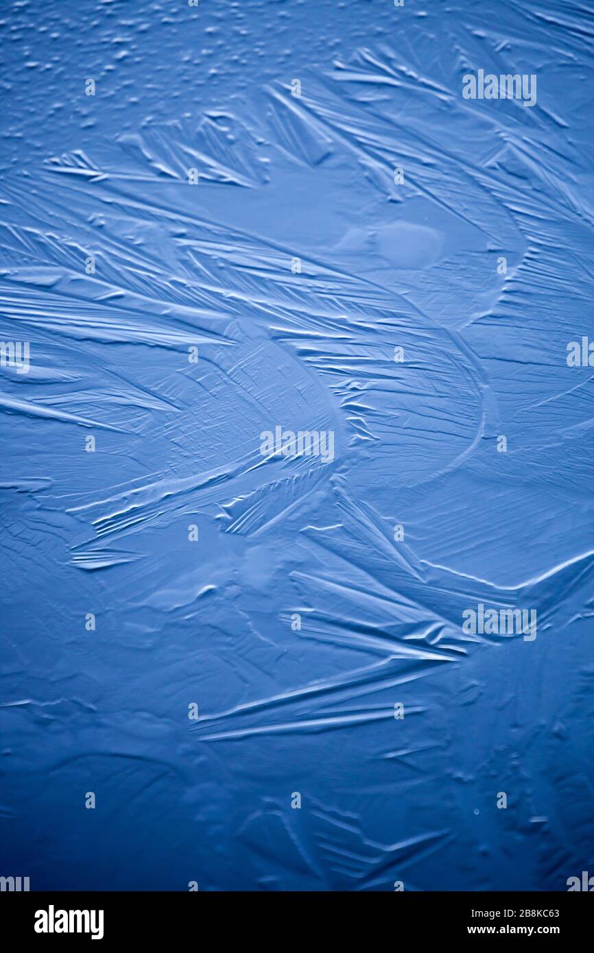 Frozen water with interesting patterns in blue Stock Photo - Alamy