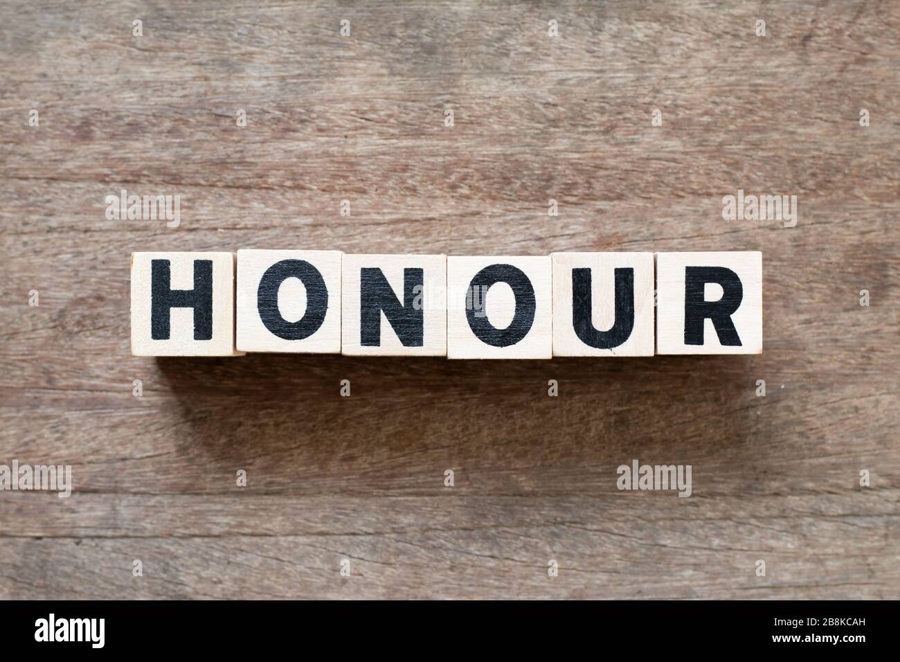 Letter block in word honour on wood background Stock Photo - Alamy