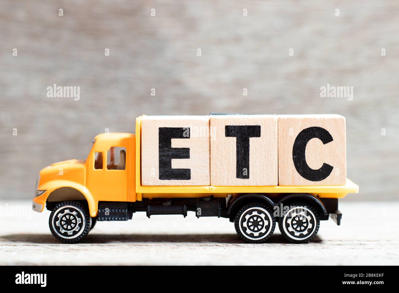 Truck hold letter block in word etc (abbreviation of et cetera) on wood ...