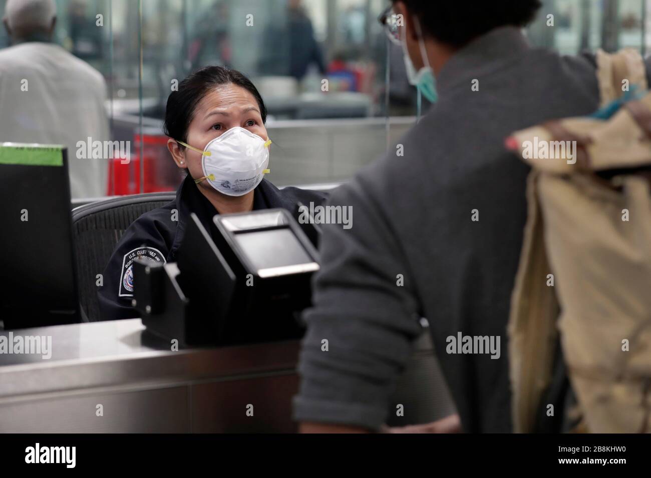 A U.S. Customs and Border Protection officer screens international ...
