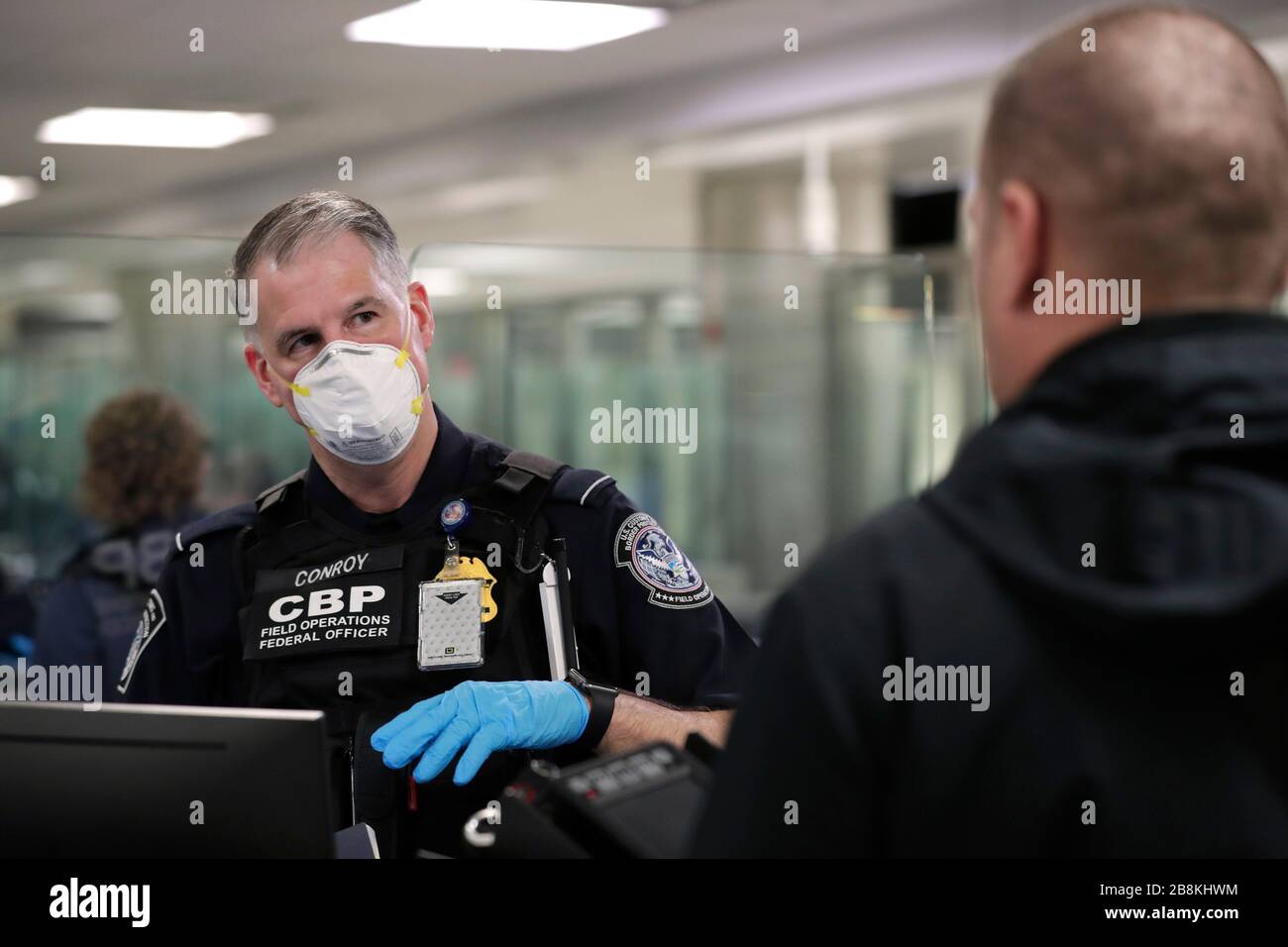 A U.S. Customs and Border Protection officer screens international ...