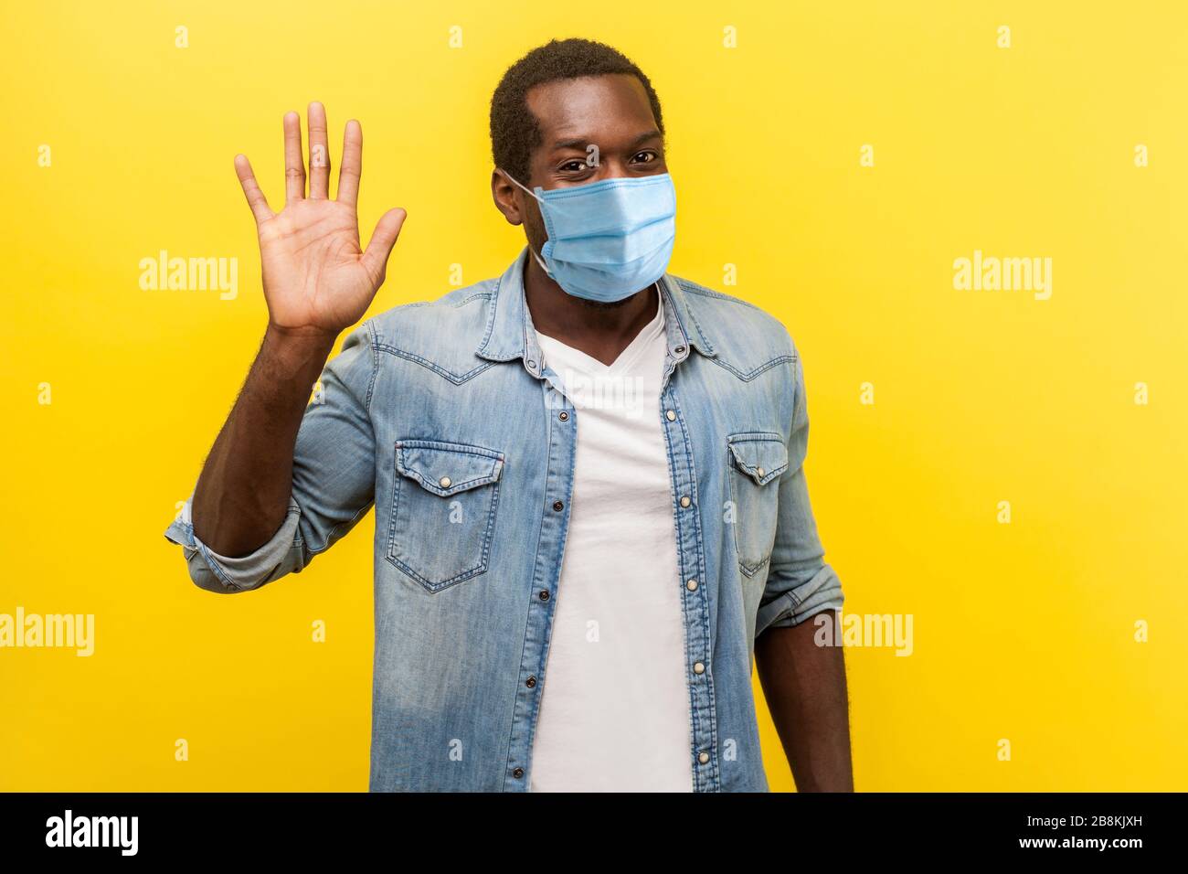 Hello! Portrait of positive handsome man with medical mask with rolled ...
