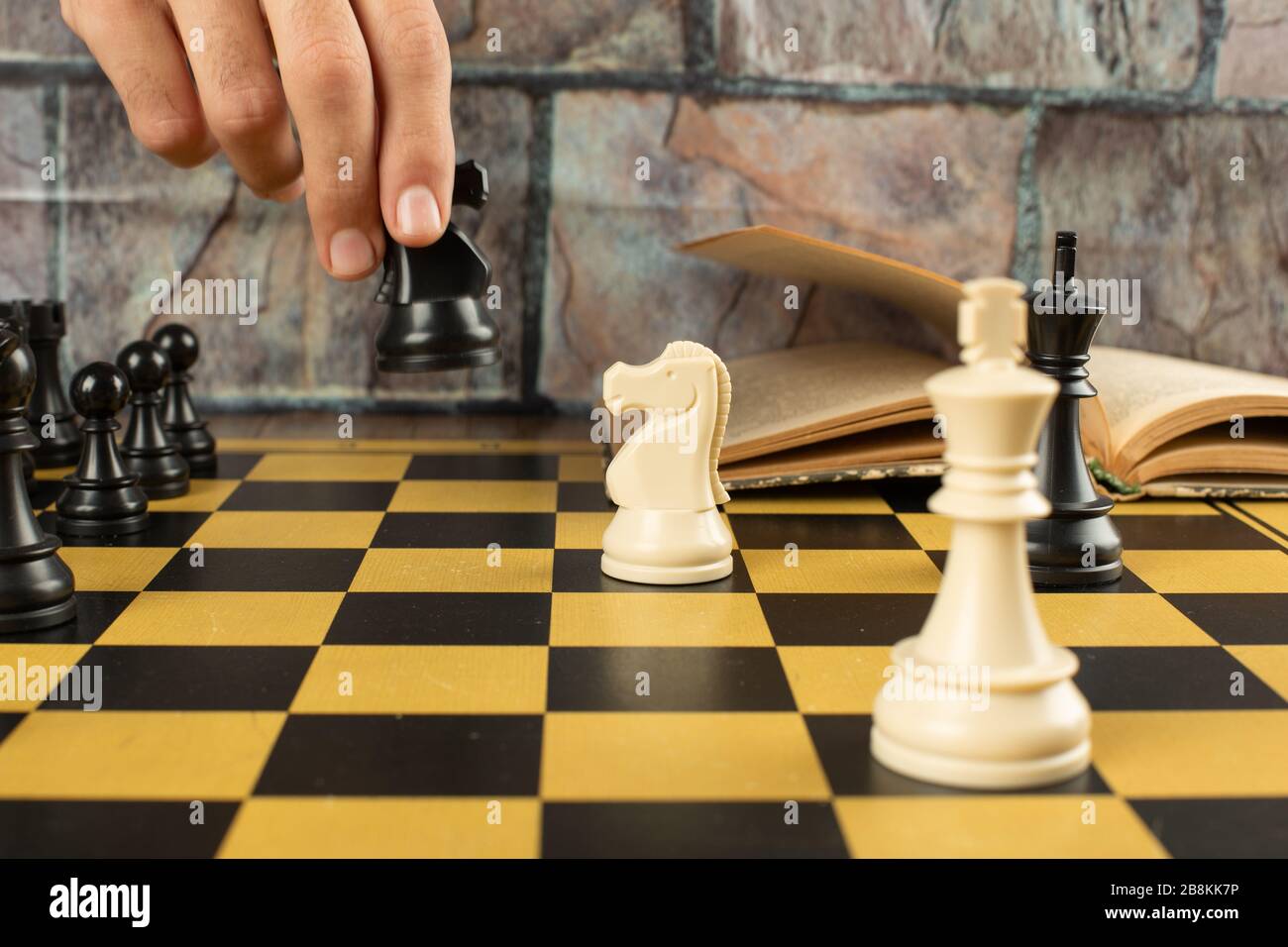 Chess figures position and a player playing chess Stock Photo - Alamy