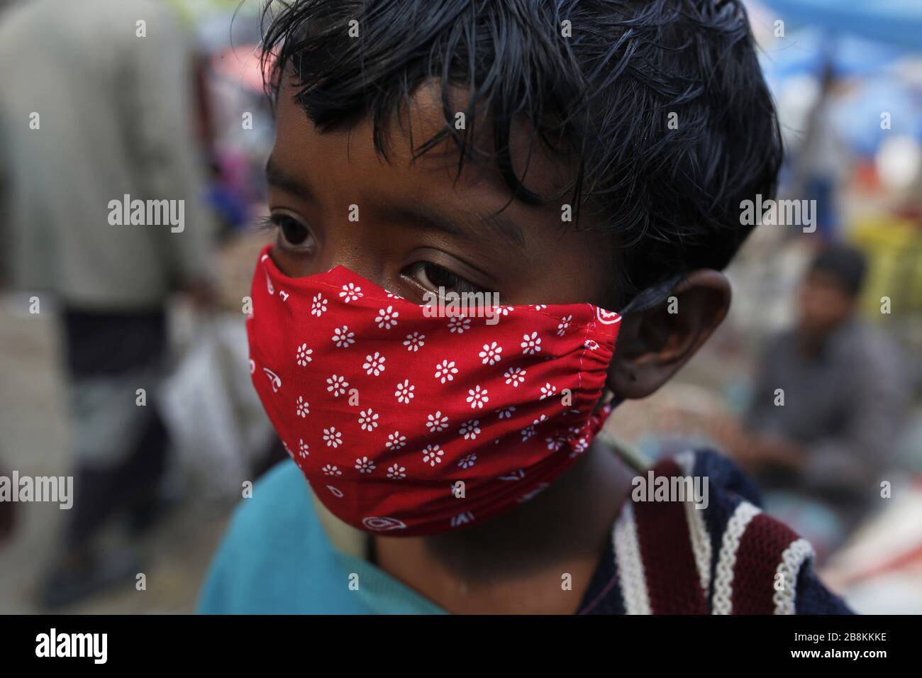 Naogaon, Bangladesh. 22nd Mar, 2020. A child wears a face mask to ...