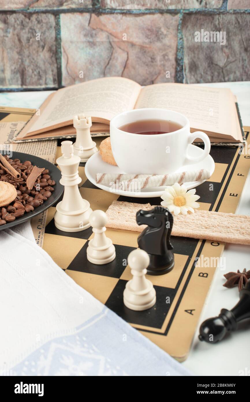 A cup of tea and some chess figures on a chessboard Stock Photo - Alamy