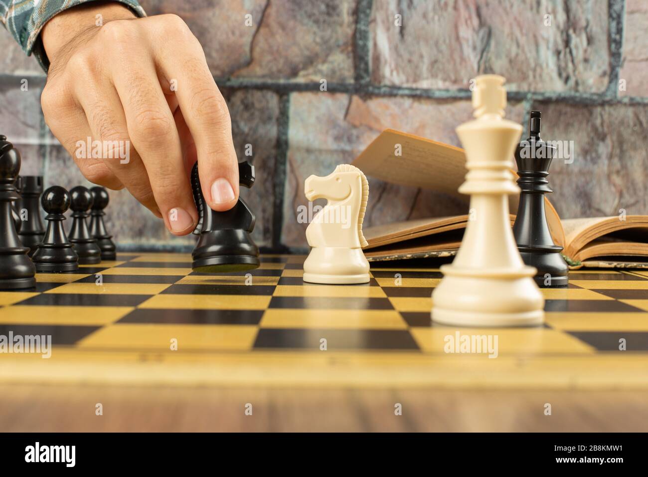 Chess figures position and a player Stock Photo - Alamy