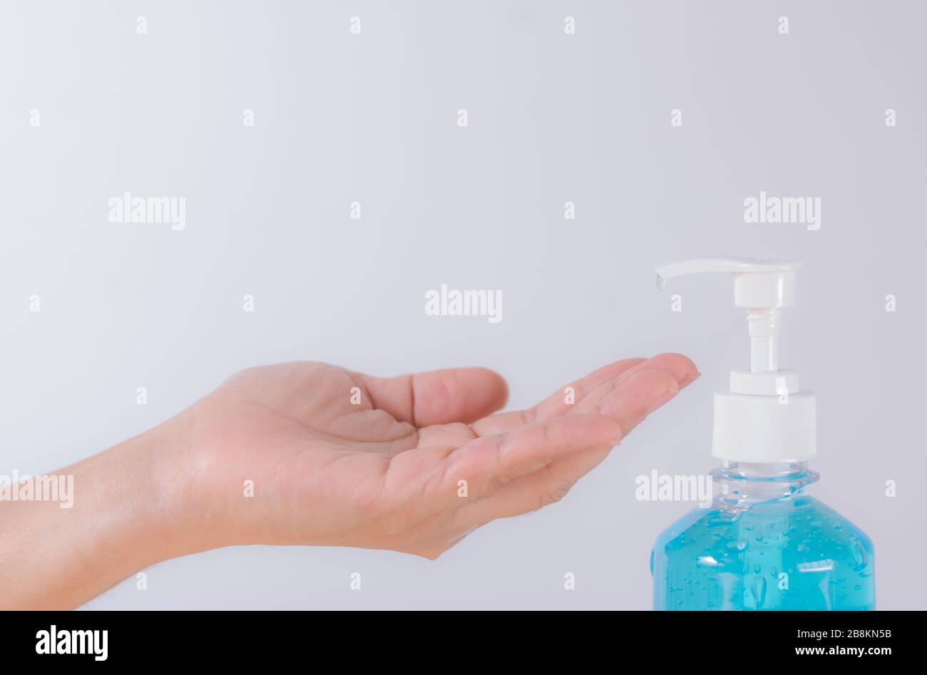 Close up woman hand take cleaner from alcohol sanitizer bottle ...
