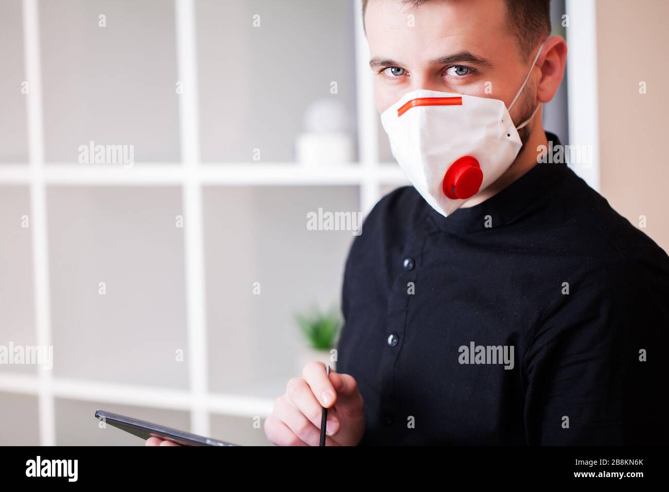 Man working in the office wearing a mask for protection from ...