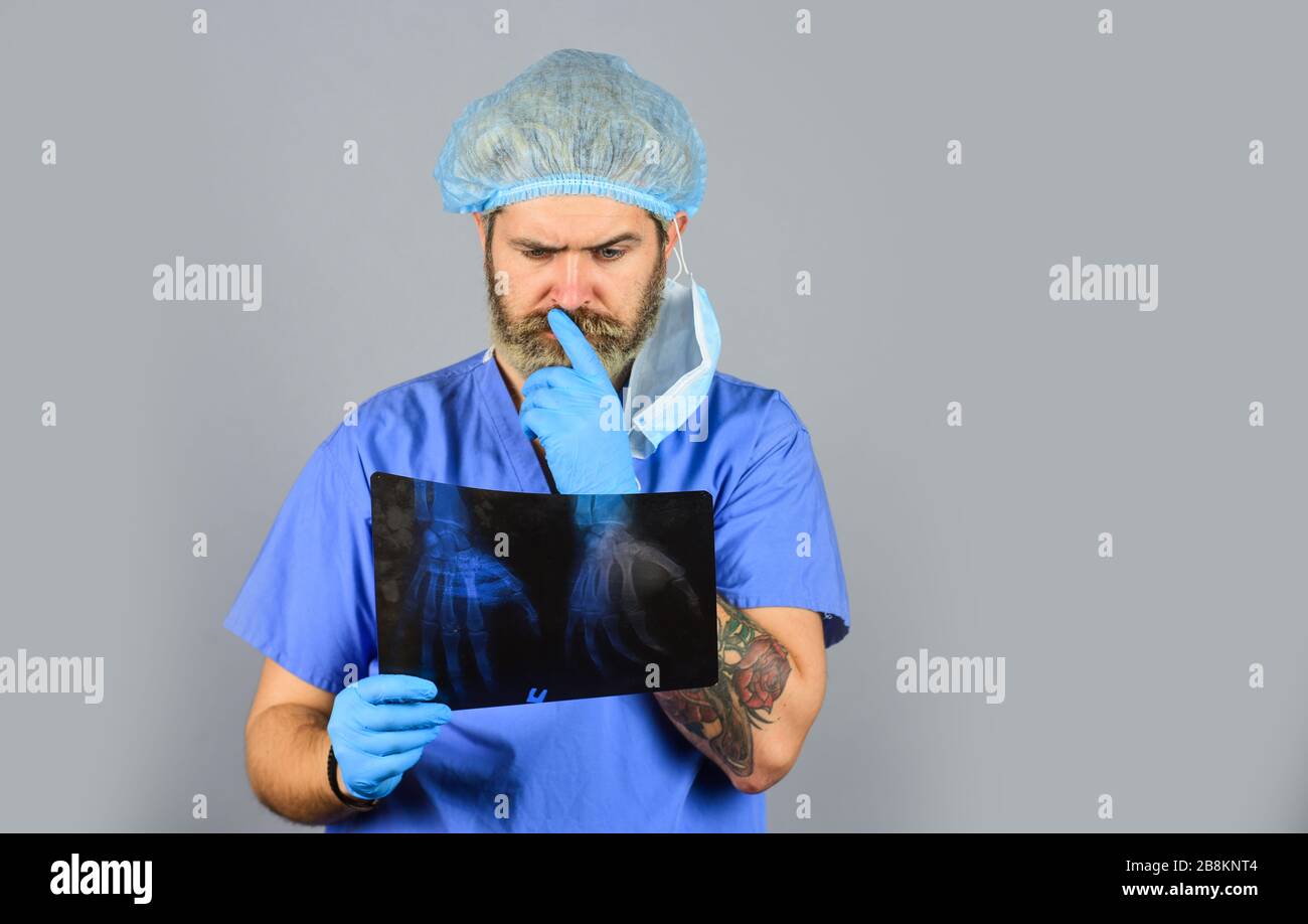 Fracture and bone damage. Doctor examines radiographic snapshot of ...