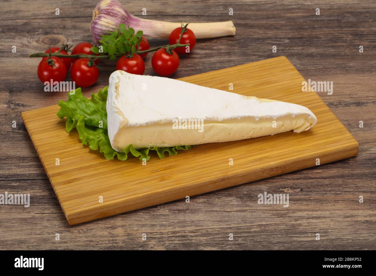 Brie cheese triangle served salad leaves Stock Photo - Alamy