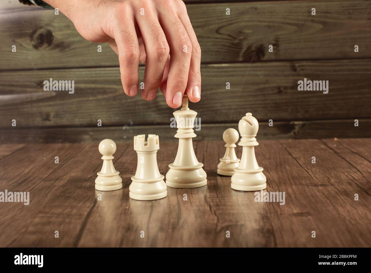 A player hand taking white king Stock Photo - Alamy