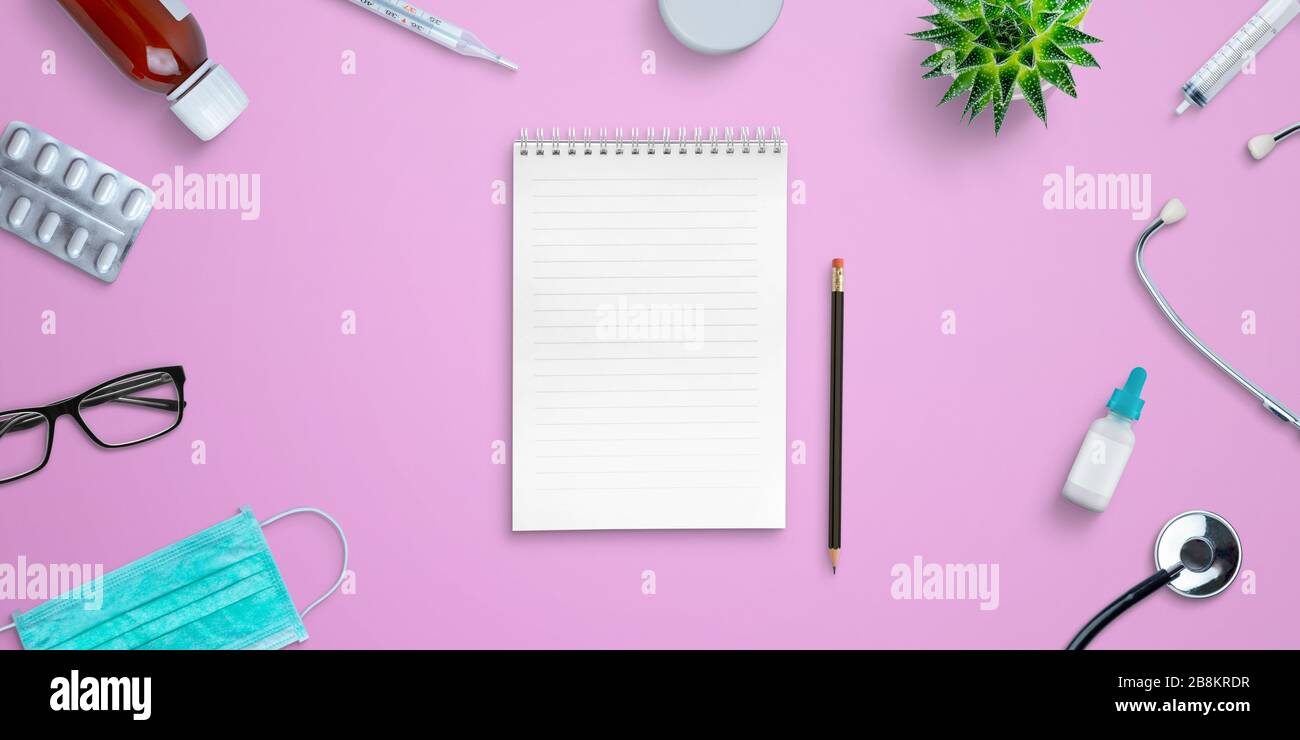 Empty notepad on hospital desk surrounded by medical equipment and ...