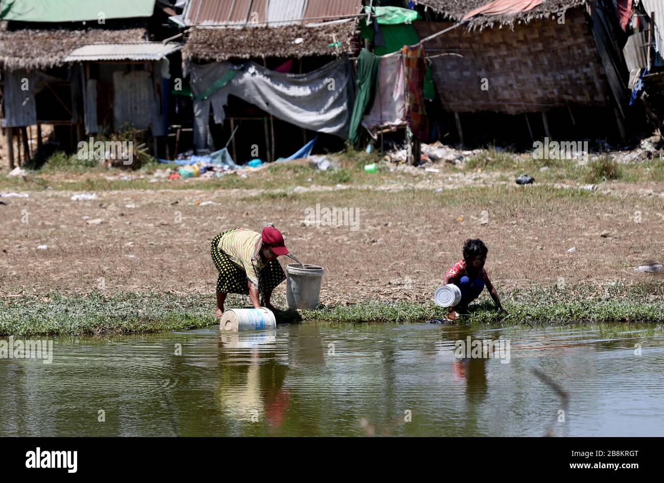 Yangon, Myanmar. 22nd Mar, 2020. Residents fetch water at Dala Township ...
