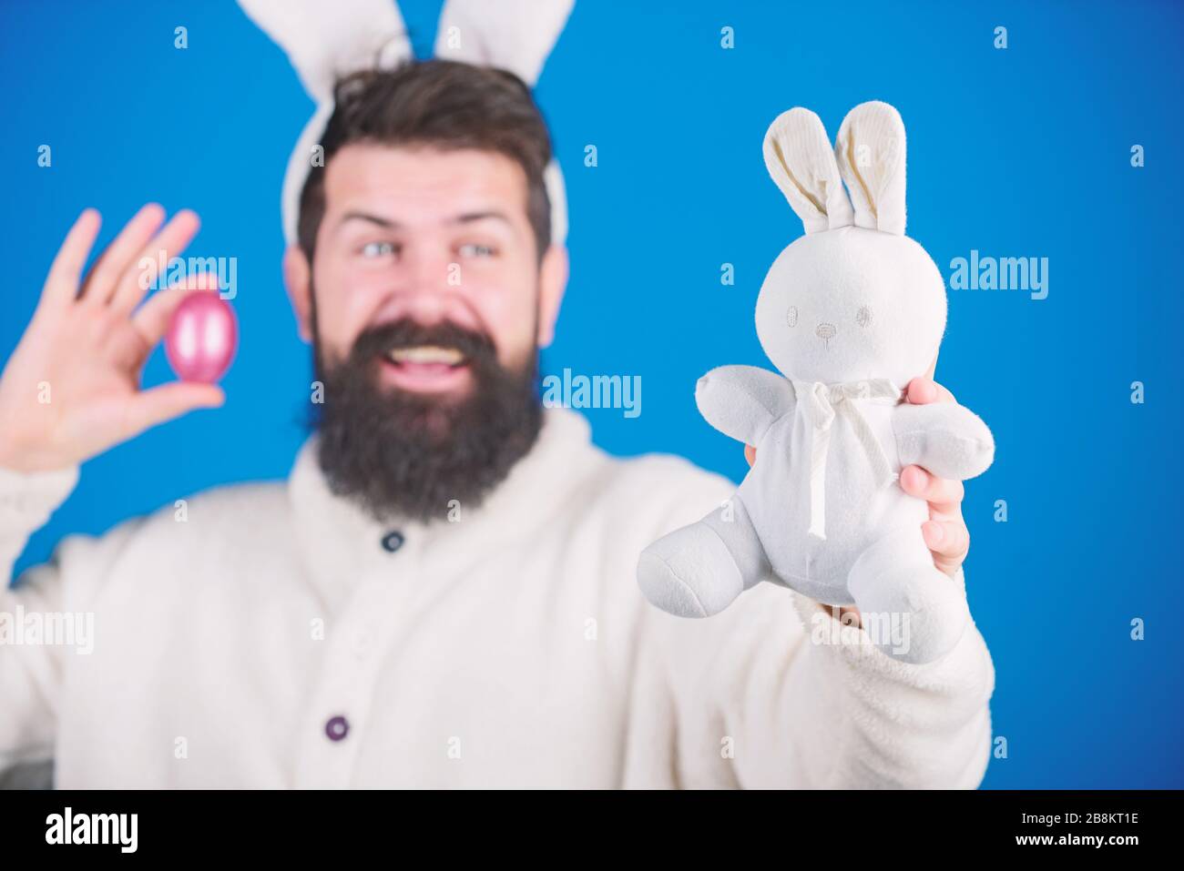 Easter fun. Bearded man with bunny toy and Easter egg. Hipster with ...