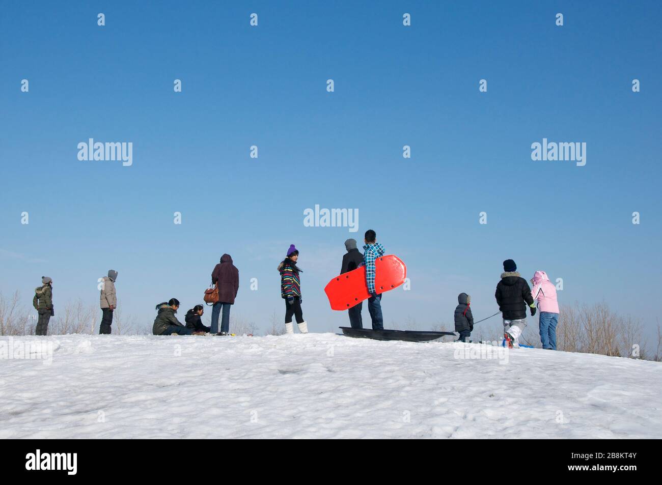 Winter sport toboggan - Child playing toboggan on the hill slope in ...