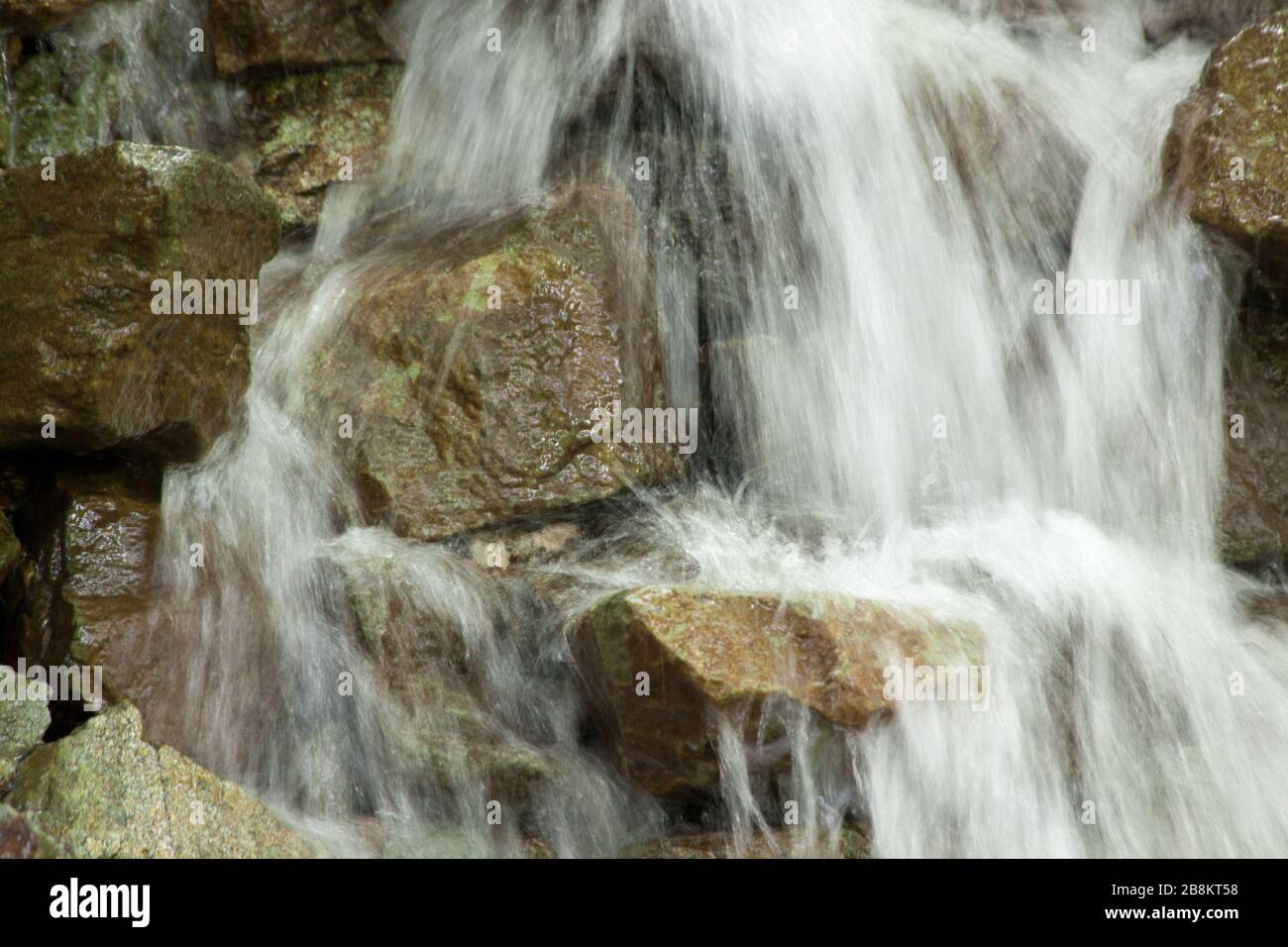 Water falling over rocks Stock Photo - Alamy