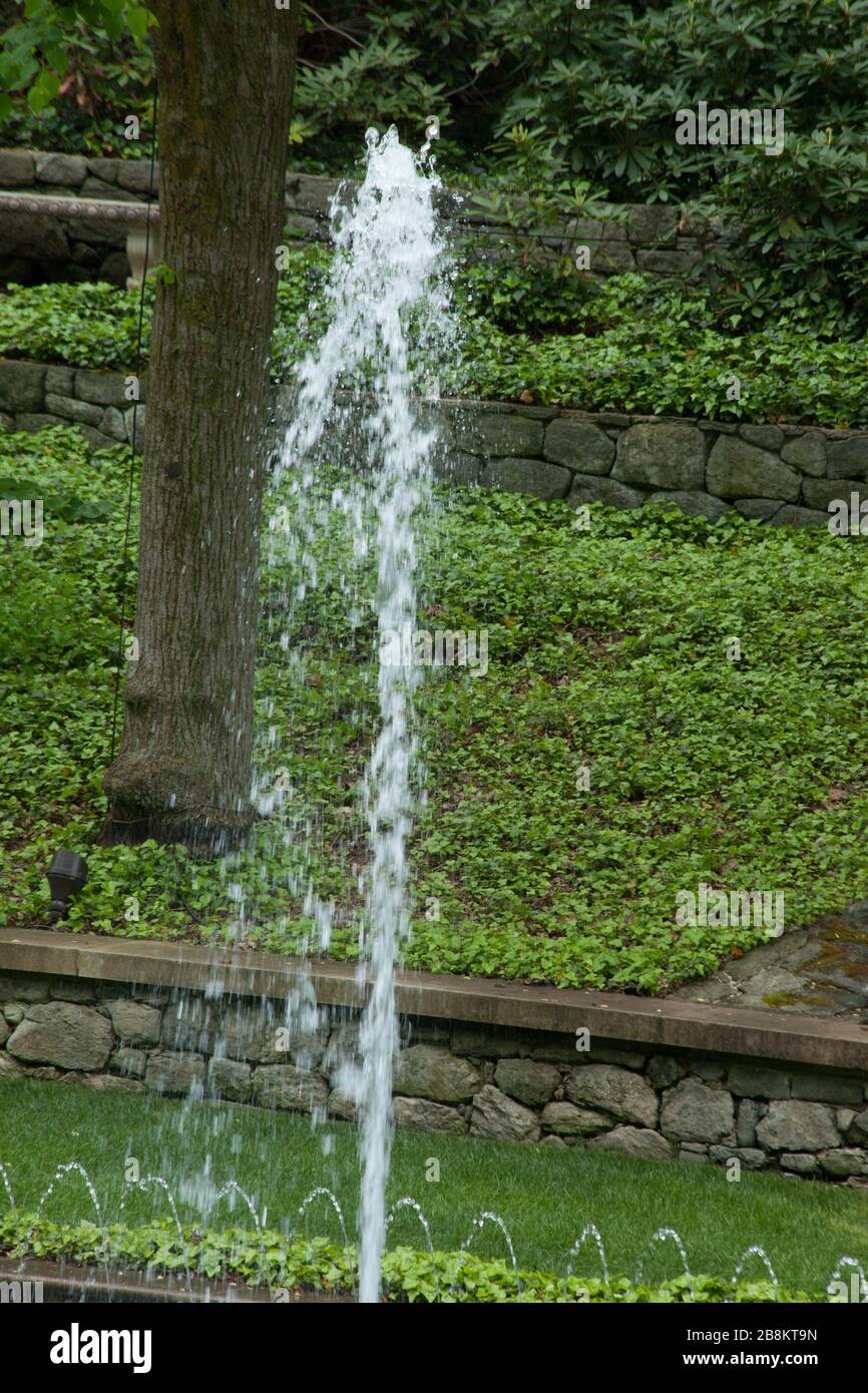 Fountain with green background Stock Photo - Alamy