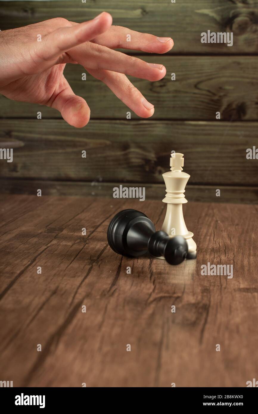 A hand, checkmate, king and queen Stock Photo - Alamy