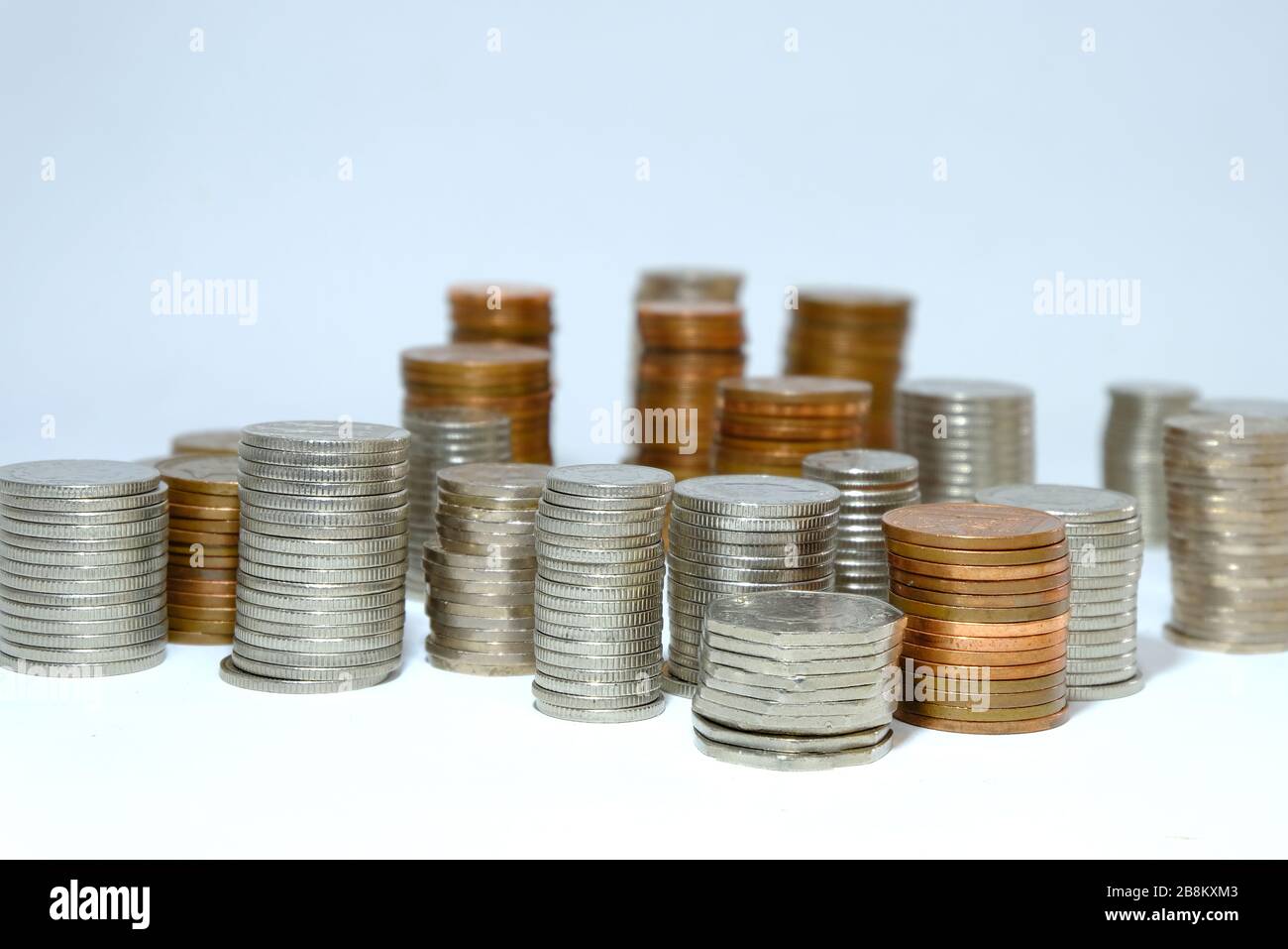Coins stacked up in piles Stock Photo - Alamy