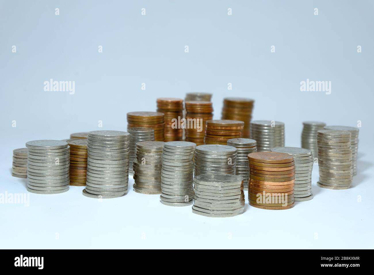 Coins stacked up in piles Stock Photo - Alamy