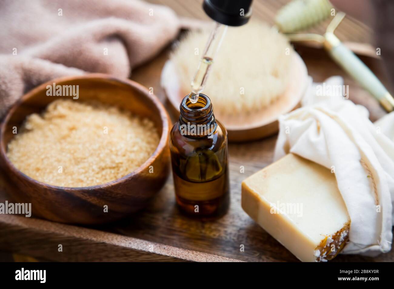 Spa still life with oil bottle and pipette, brown sugar scrub,natural ...