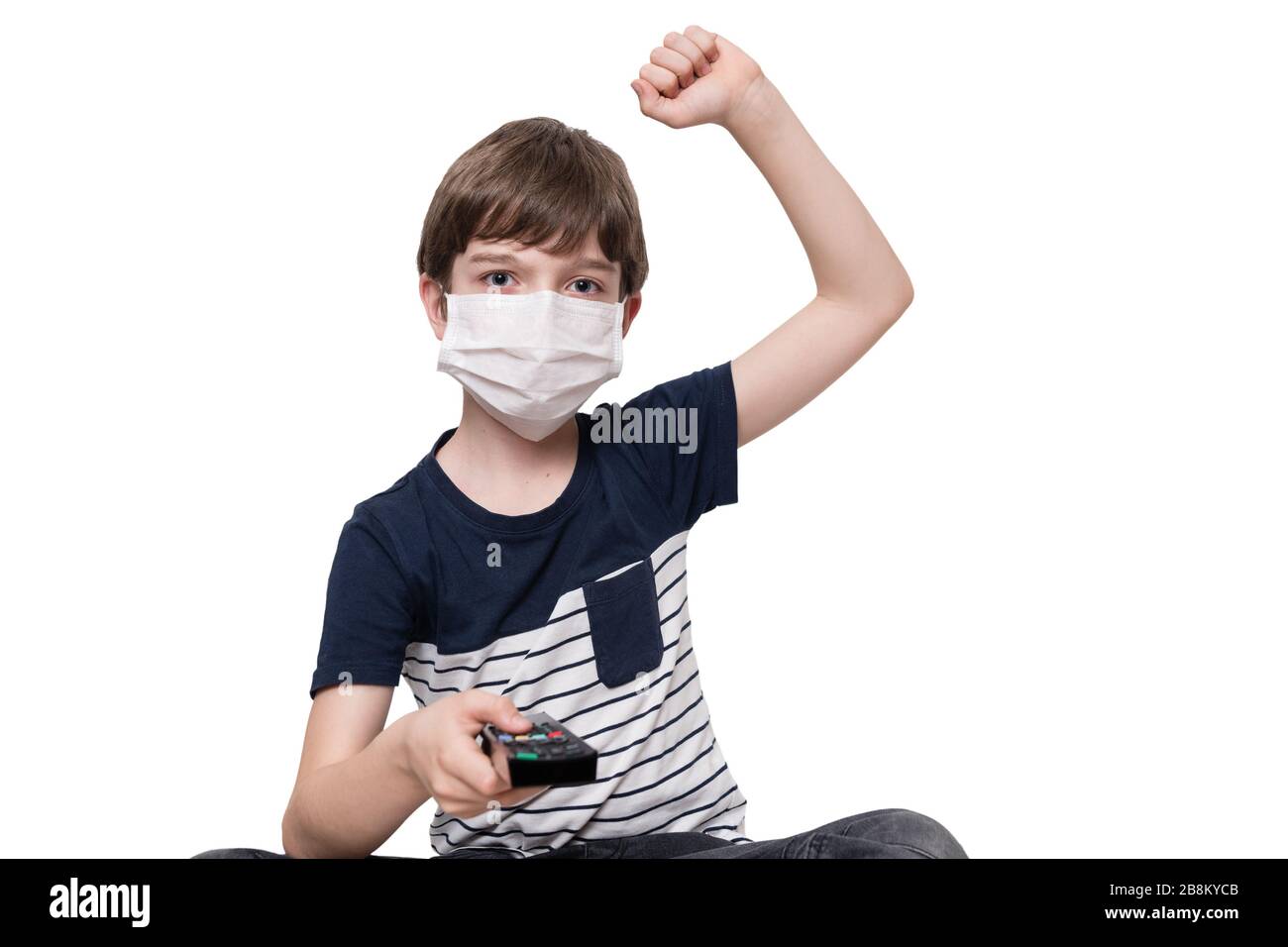 Happy kid with face mask holding remote controller, isolated on white ...