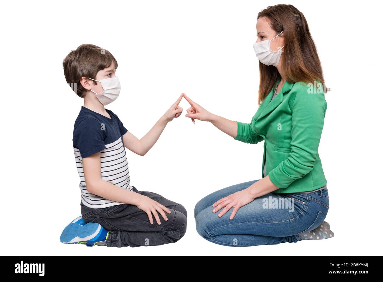Mother and child with face masks gently touching with the index fingers ...