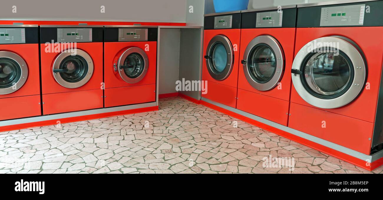 Automatic laundromat for washing cloths inside a store Stock Photo - Alamy