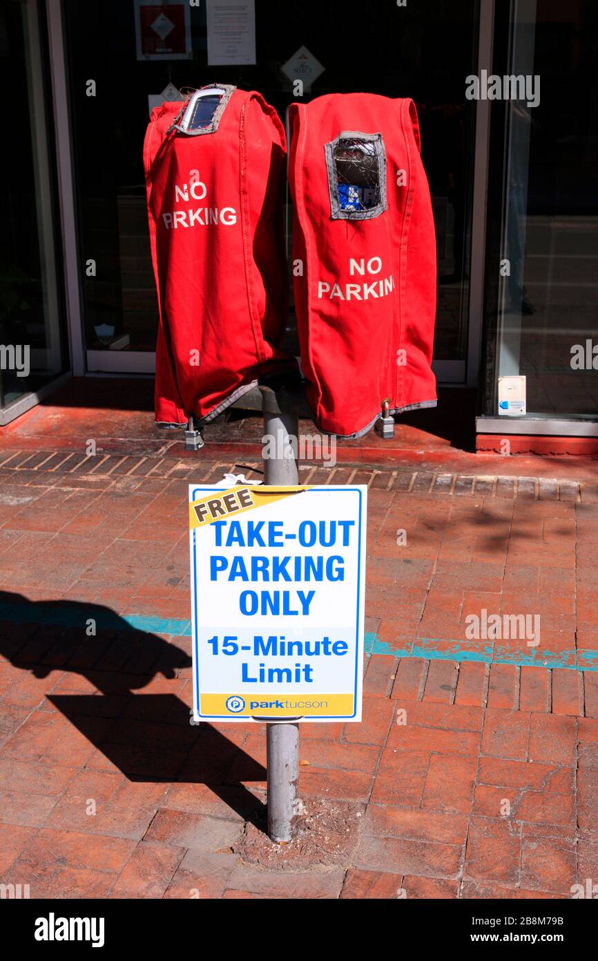 Parking meters cclosed with signs offering free 15minute parking for ...