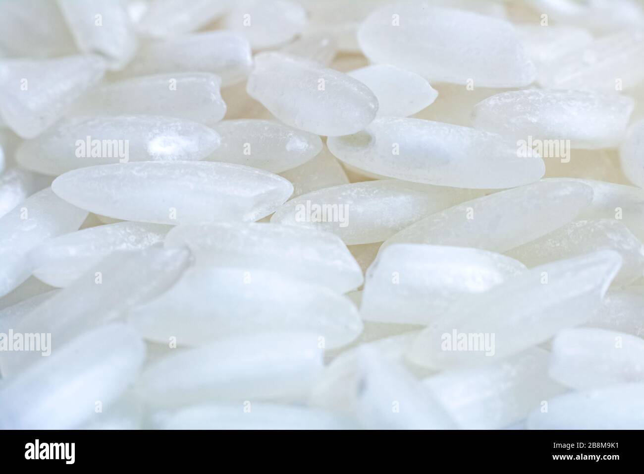 White rice grains closeup, background and texture Stock Photo - Alamy