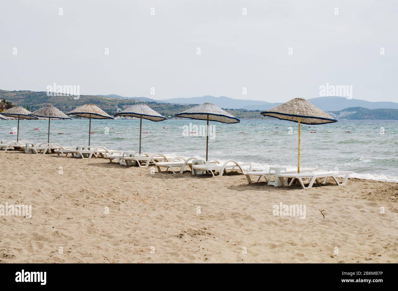 Rows of empty sun loungers and umbrellas on the beach. Camel Beach in ...