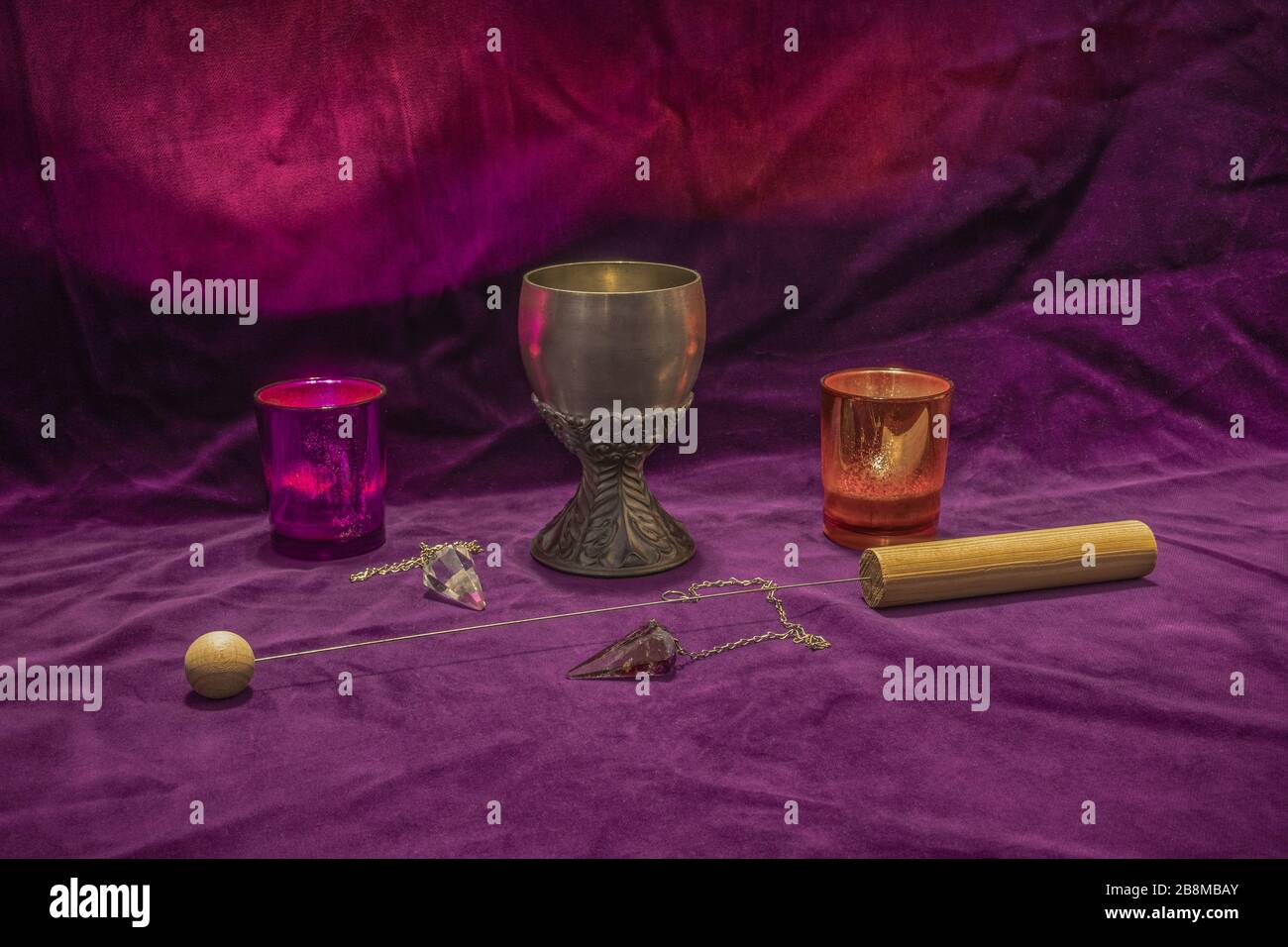 Divining rod, crystal dowsing pendulus, candles and a tin chalice ...