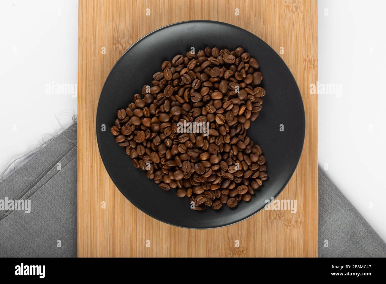 Heart shaped coffee beans in a saucer Stock Photo - Alamy
