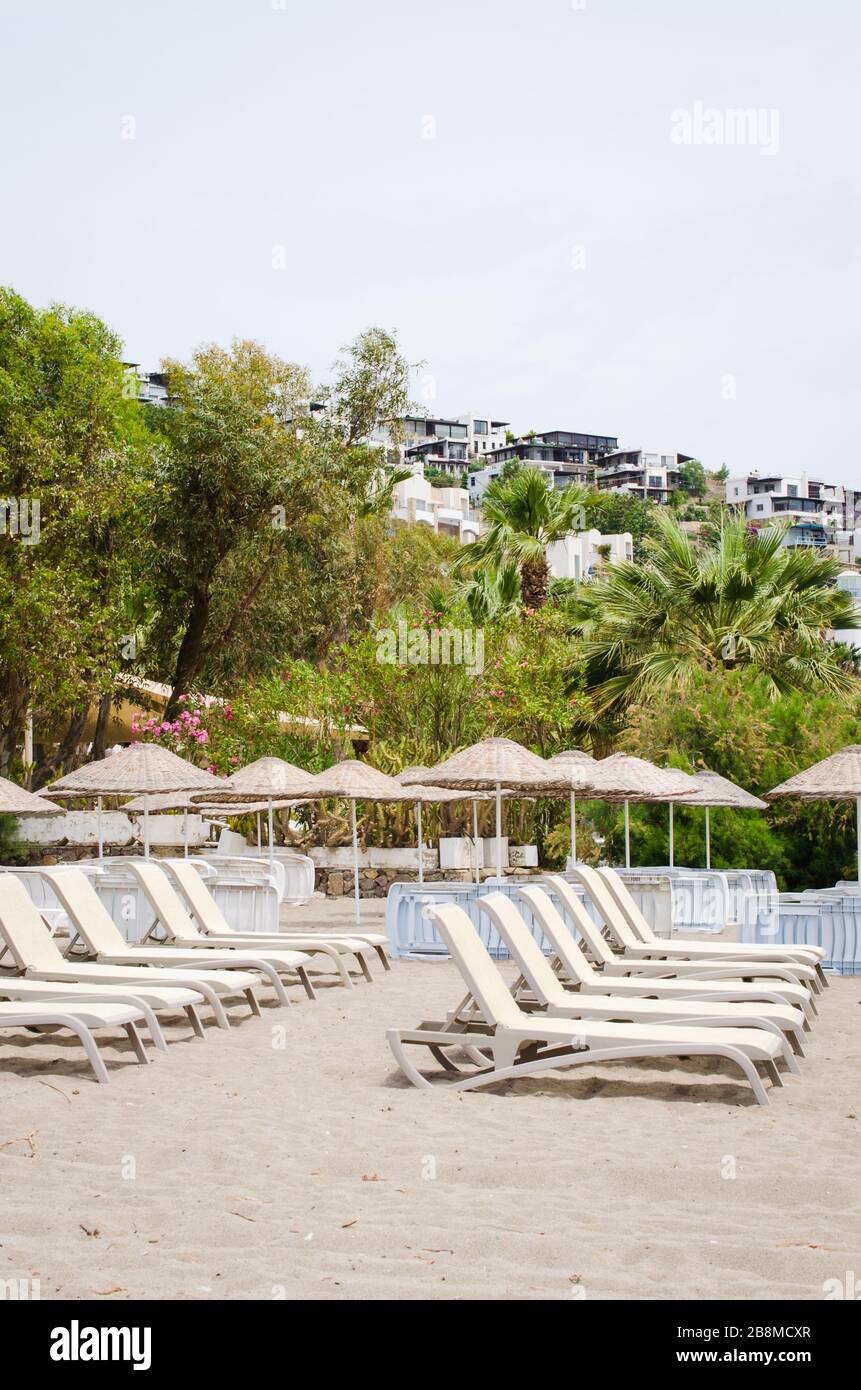 Rows of empty sun loungers and umbrellas on the beach. Camel Beach in ...