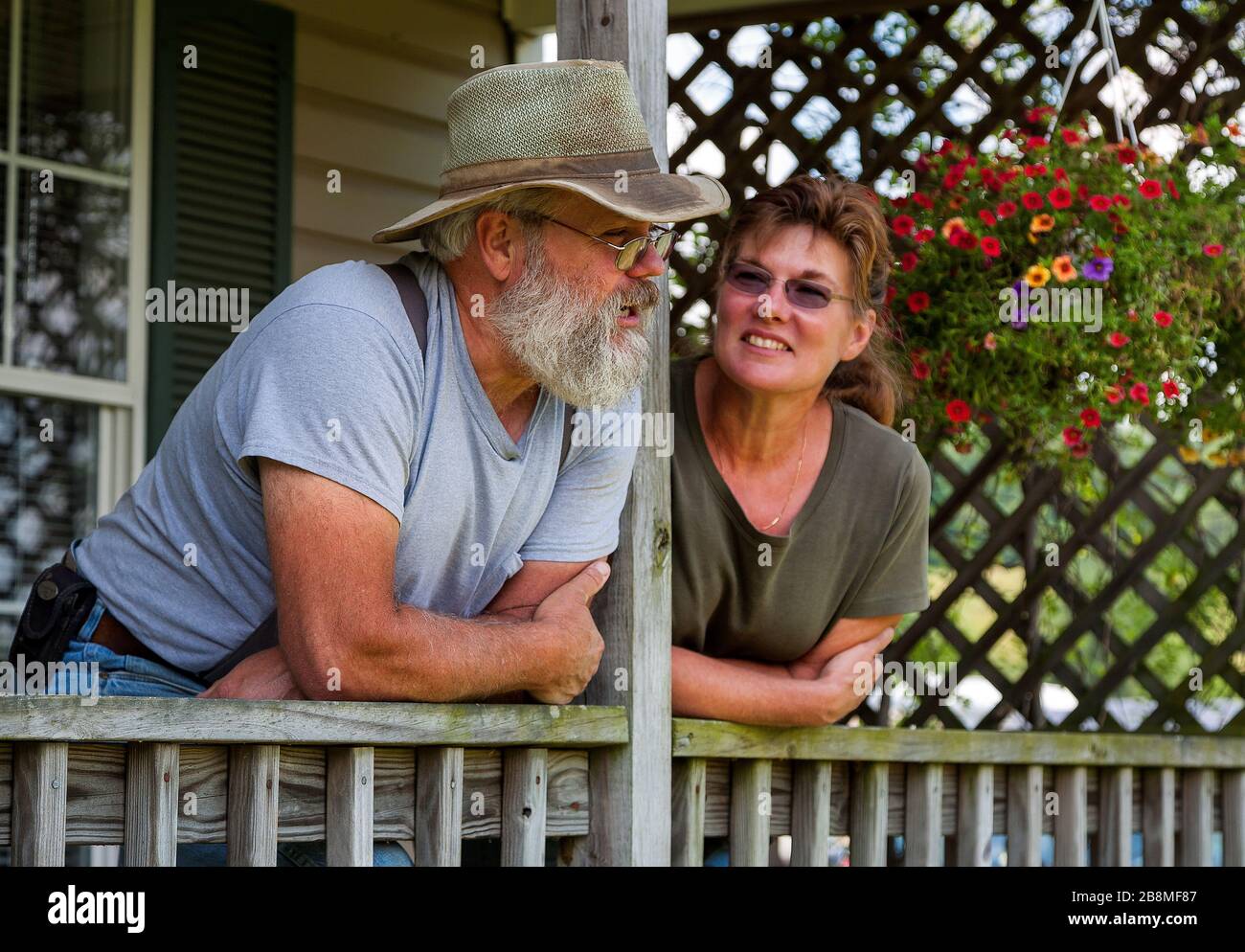 Family farm couple pose on porch Stock Photo - Alamy