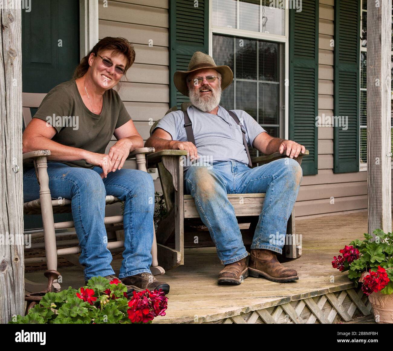 Family farm couple pose on porch Stock Photo - Alamy