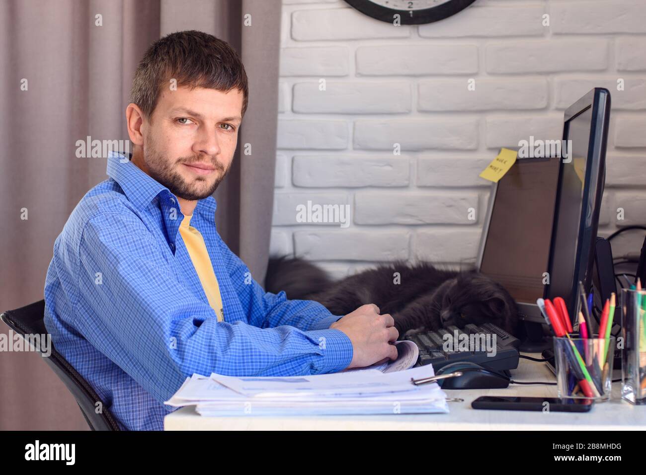 Portrait of a self-employed man working remotely Stock Photo - Alamy