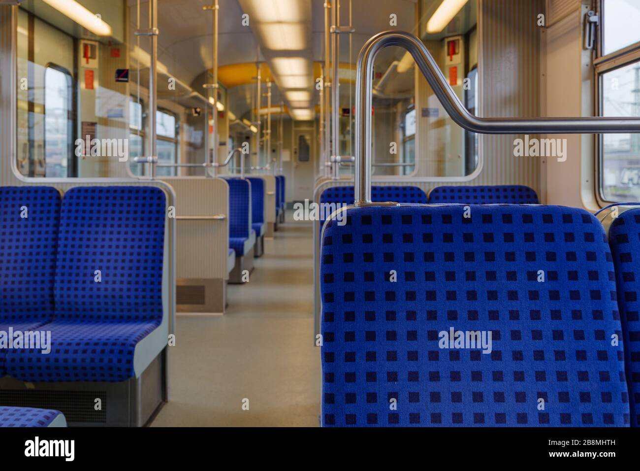 Interior view of a corridor inside passenger trains with blue fabric ...