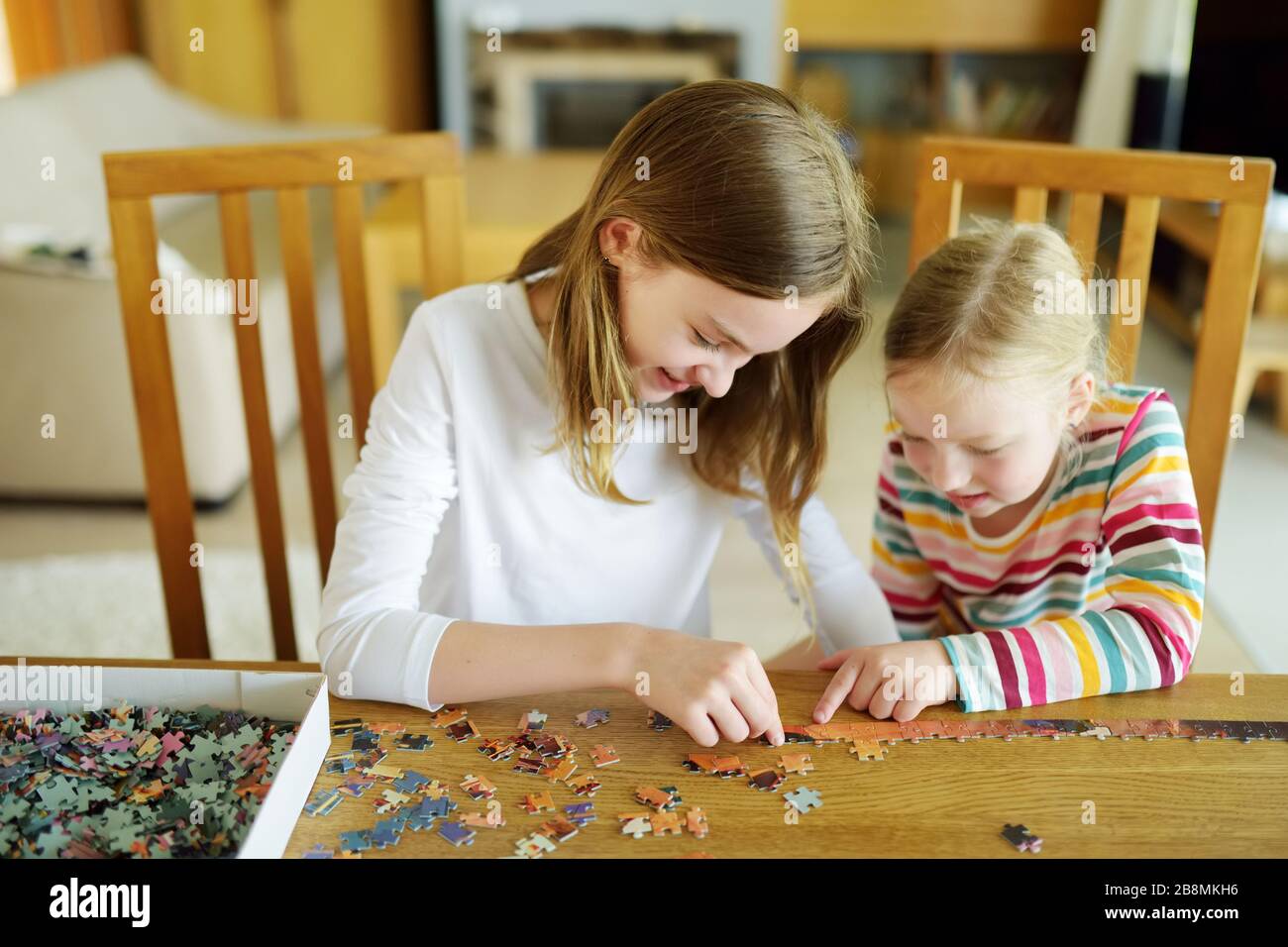 Children playing together jigsaw puzzle hi-res stock photography and ...