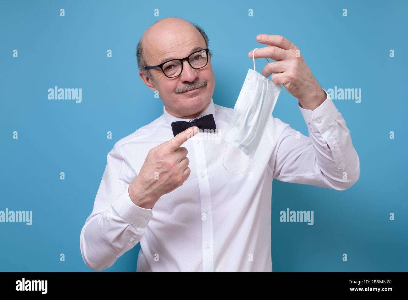 Young caucasian man with mustache pointing on a medical mask Stock ...