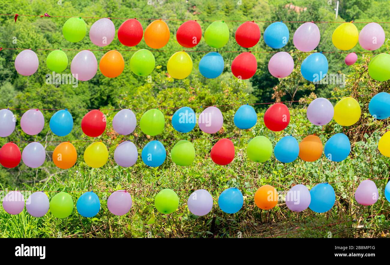 Many colorful balloons as targets for a gun in a park Stock Photo - Alamy
