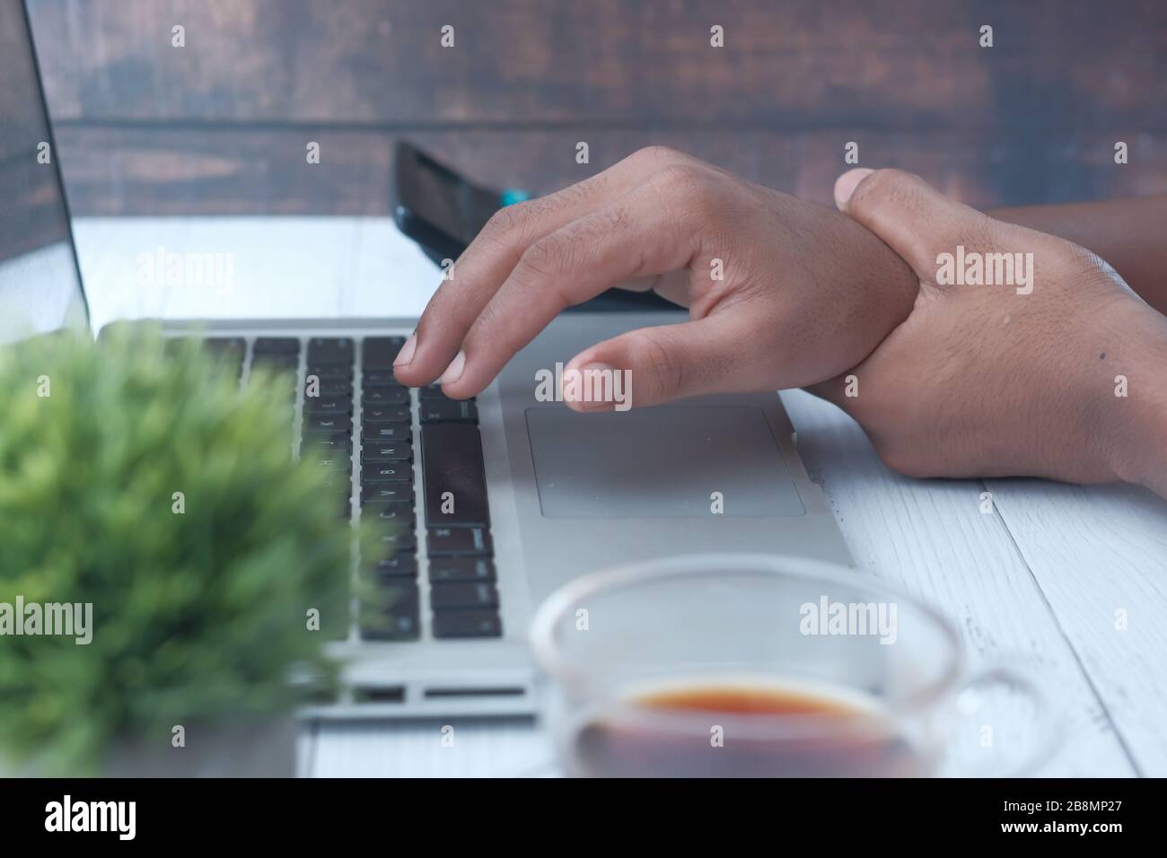 Man wrist pain using laptop hi-res stock photography and images - Alamy