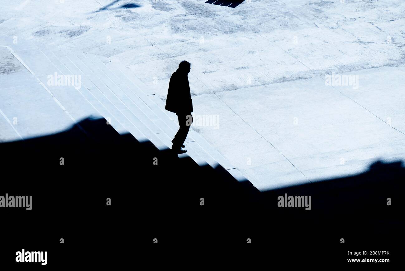 Lonely man walking down street hi-res stock photography and images - Alamy