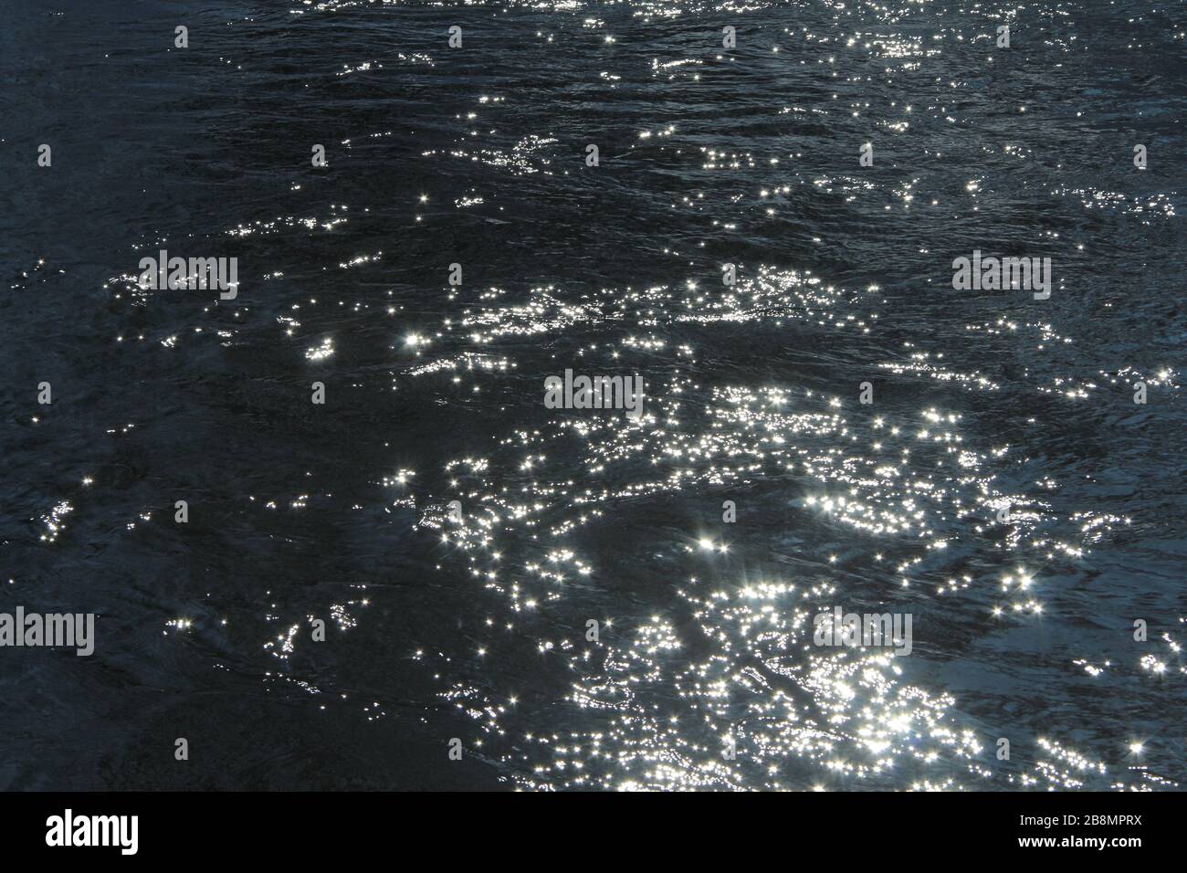 Water surface with waves and glare of light. Place for text and design ...